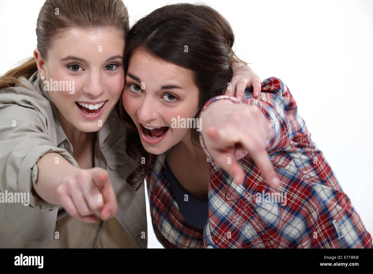 Two friends pointing at the camera Stock Photo - Alamy