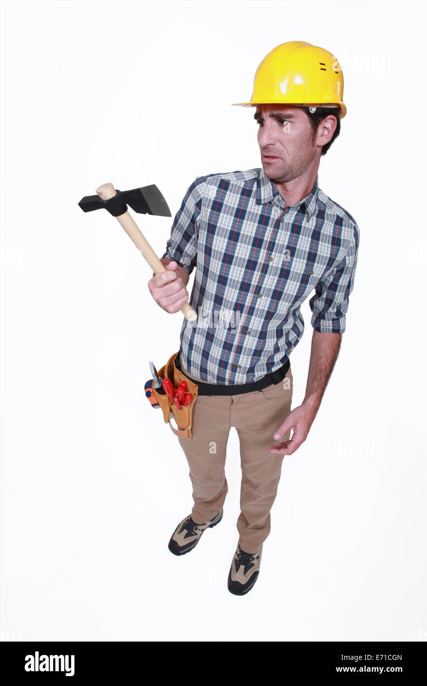 A handyman looking weirdly at his hatchet Stock Photo - Alamy