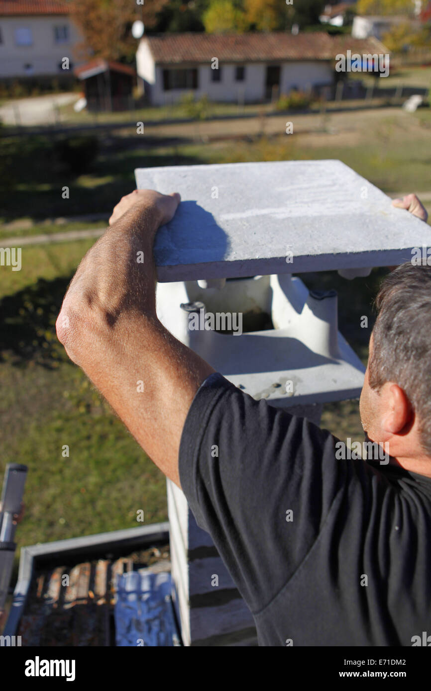 Man capping a chimney stack Stock Photo - Alamy