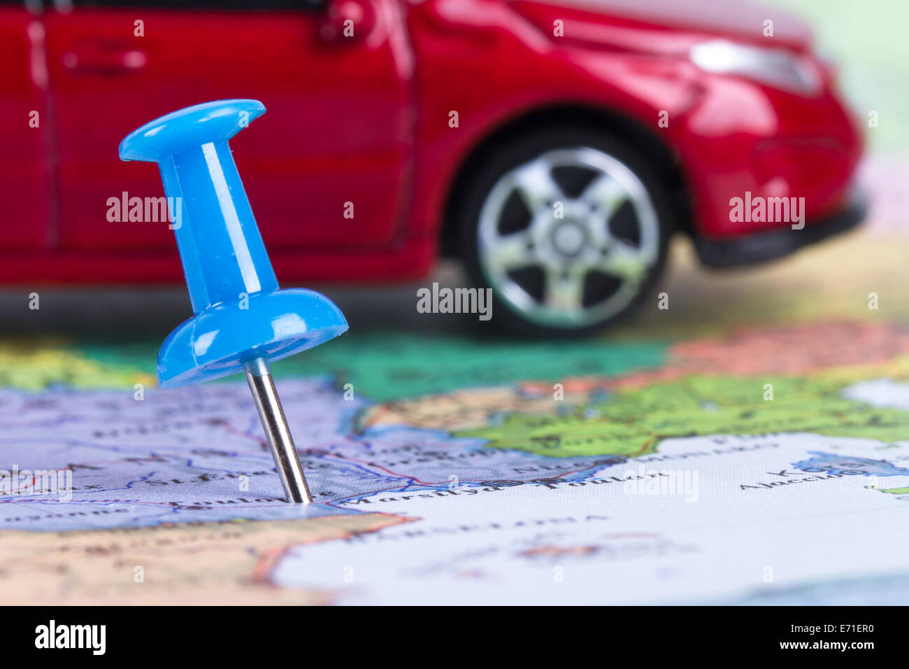 Pushpin and small, toy car on map for travel concept Stock Photo - Alamy