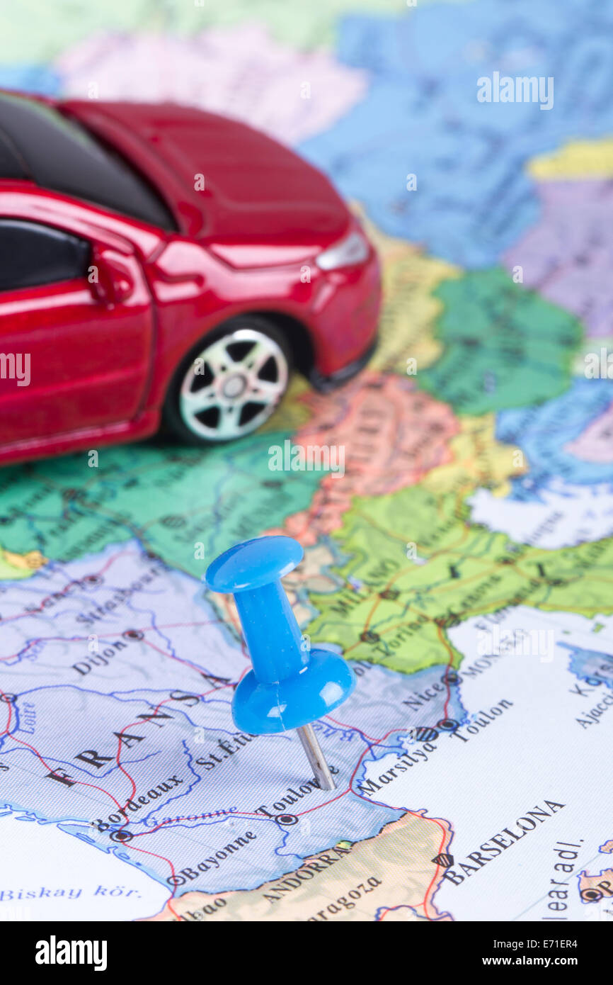 Pushpin and small, toy car on map for travel concept Stock Photo - Alamy