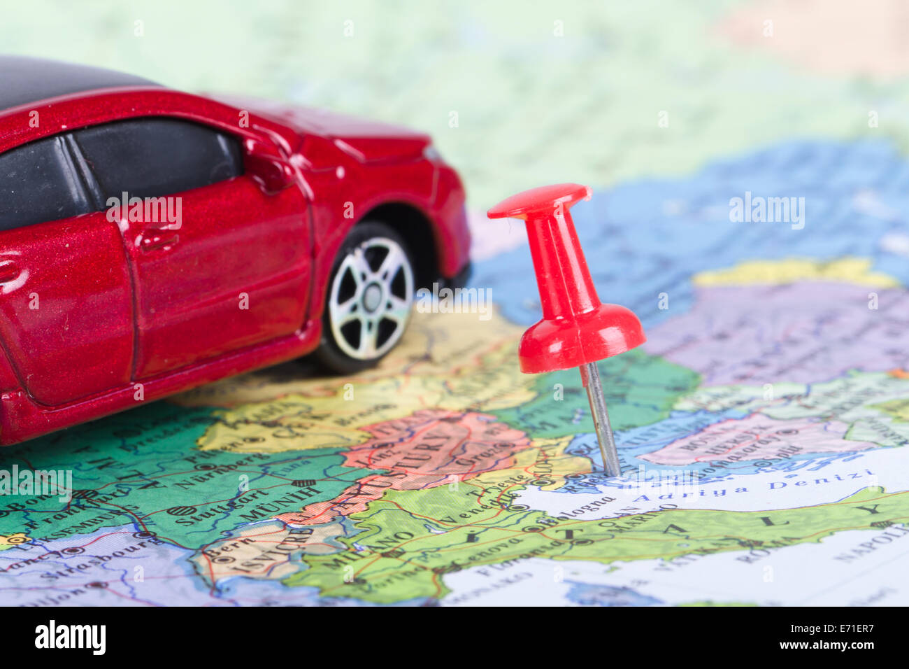 Pushpin and small, toy car on map for travel concept Stock Photo - Alamy