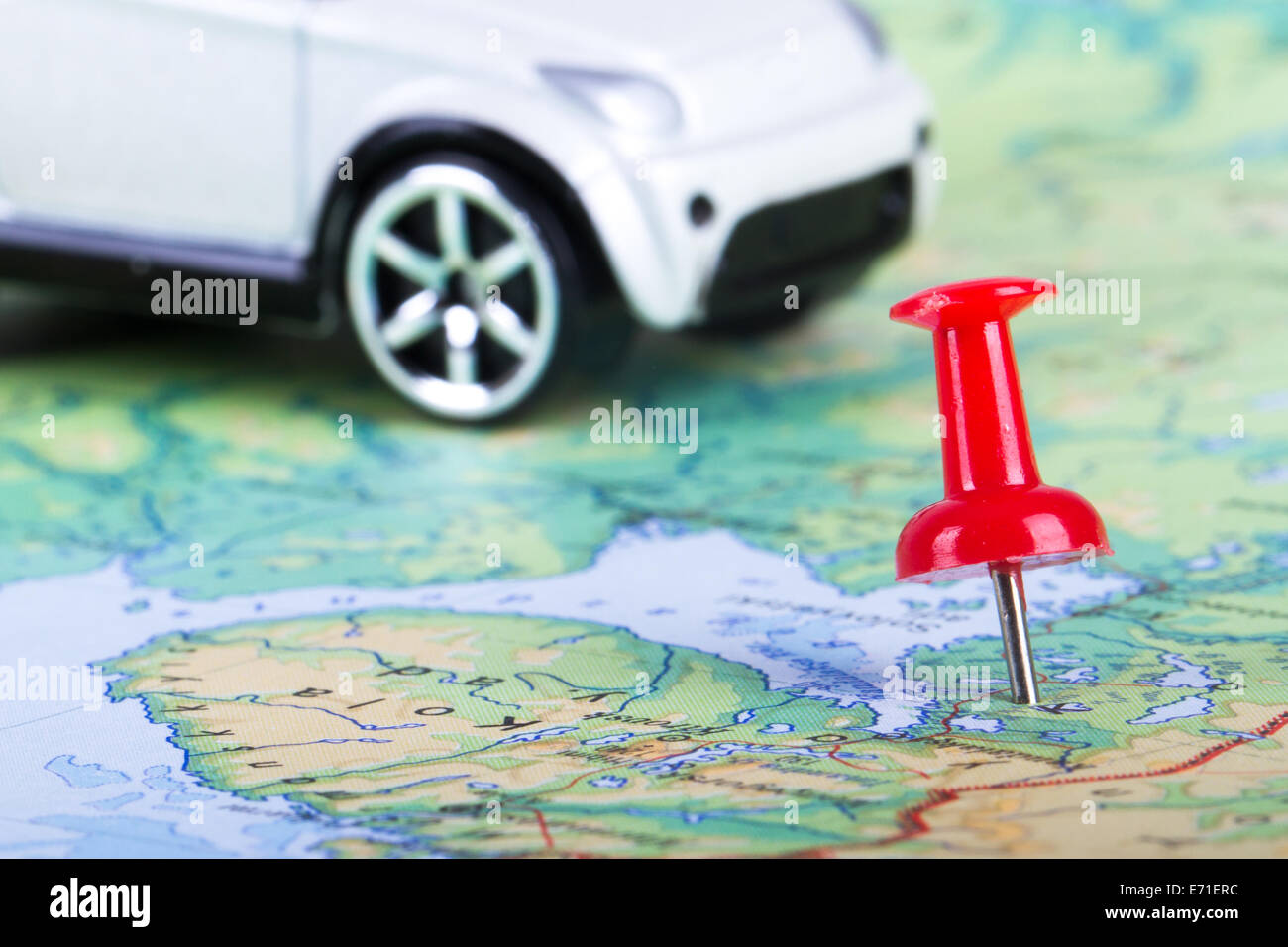 Pushpin and small, toy car on map for travel concept Stock Photo - Alamy