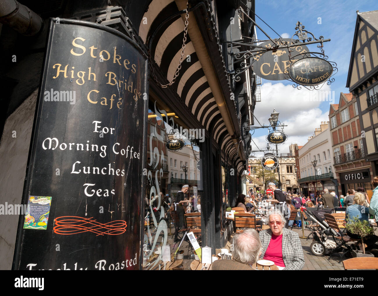 People sitting outside Stokes High Bridge Cafe, a 16th century medieval ...