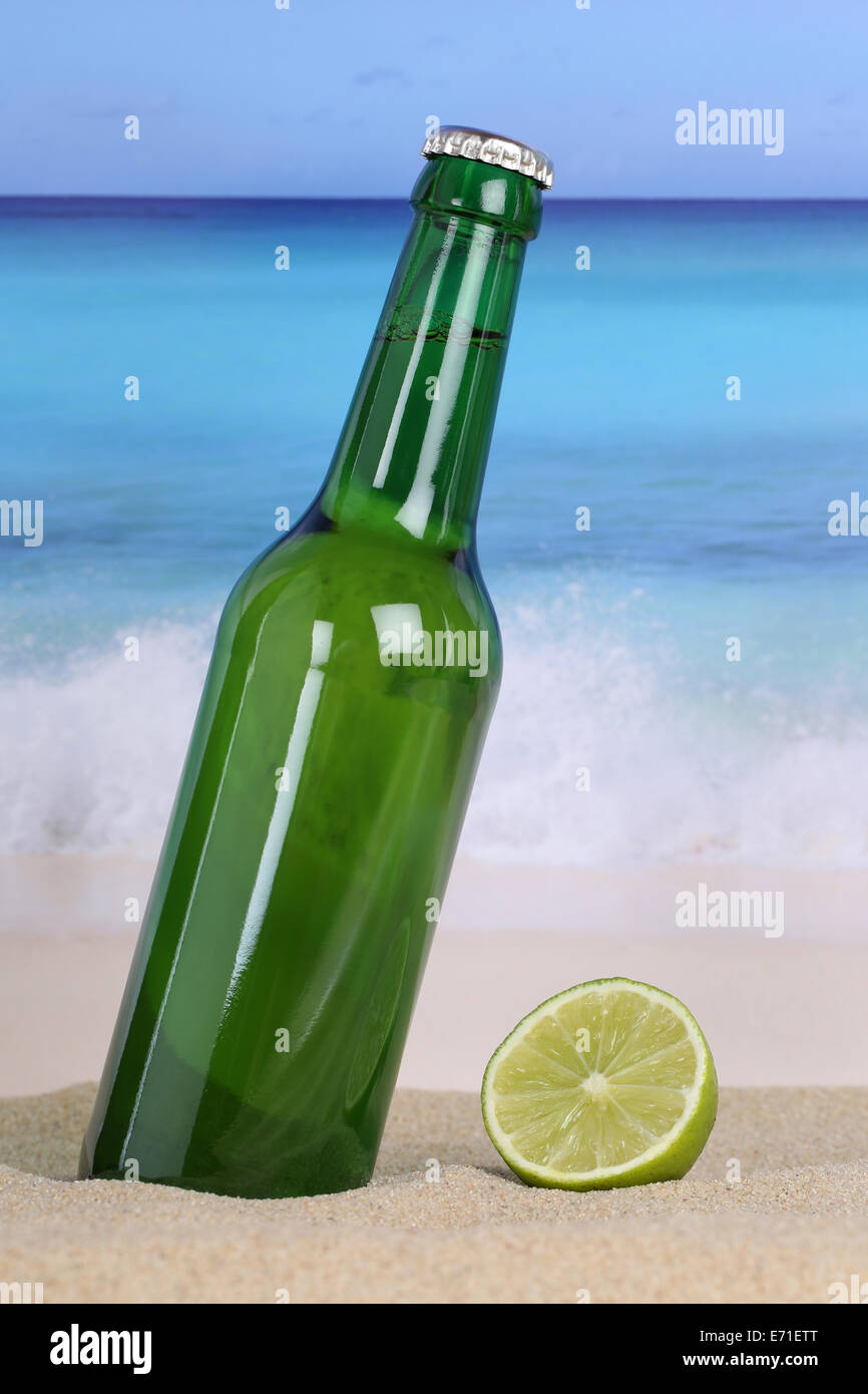 Beer in a green bottle on the beach and sea while on vacation Stock ...