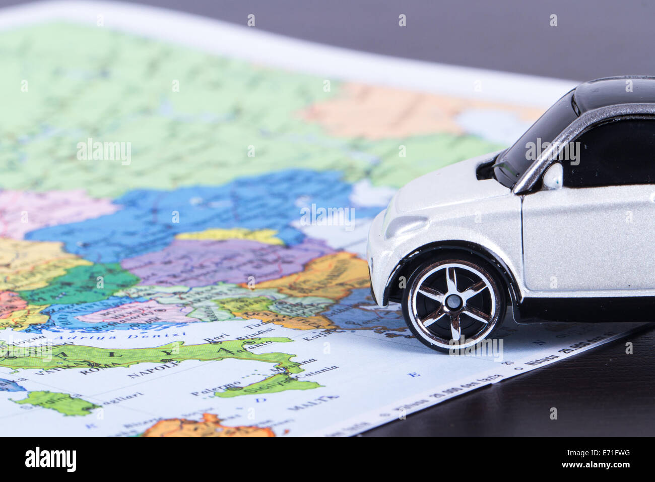 Close up view of toy car for travel concept on colorful map Stock Photo ...