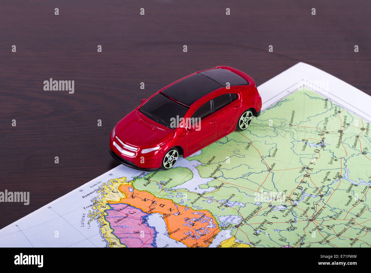 Small, toy car for travel concept on colorful map Stock Photo - Alamy