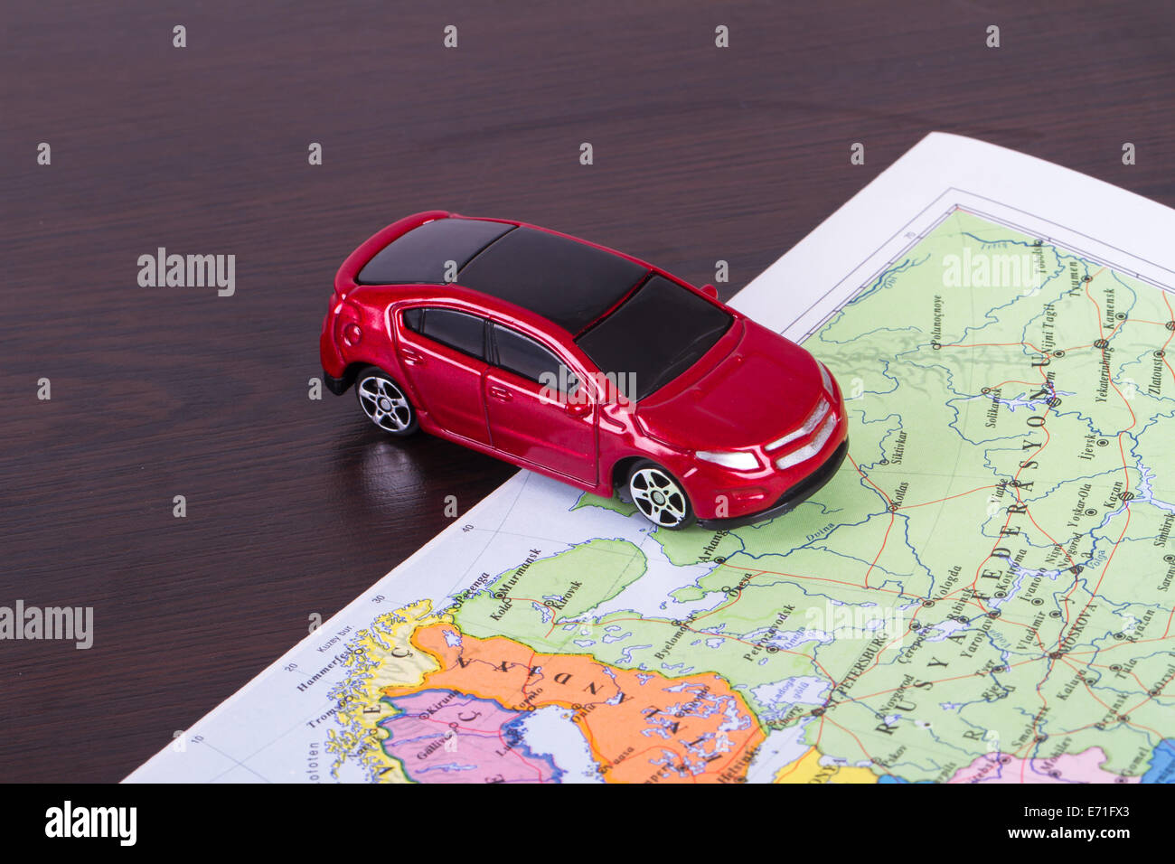 Small, toy car for travel concept on colorful map Stock Photo - Alamy