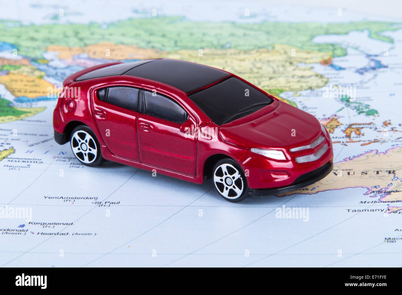 Side view of red, toy, small car on colorful map Stock Photo - Alamy
