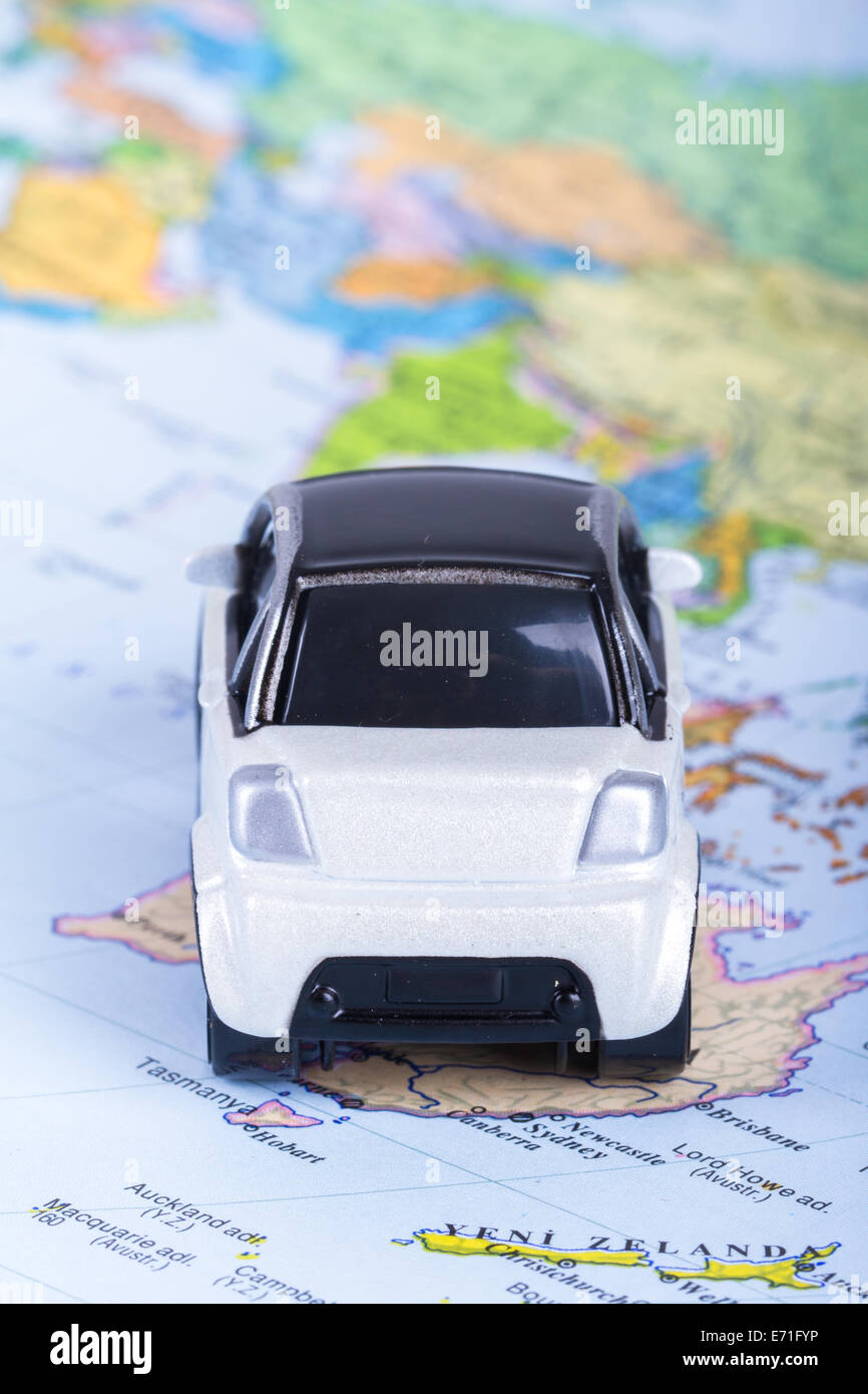 Back view of white, small, toy car on map Stock Photo - Alamy