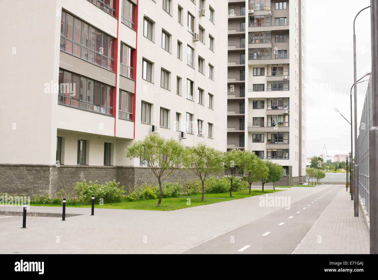 Modern building with road, grass and trees Stock Photo - Alamy