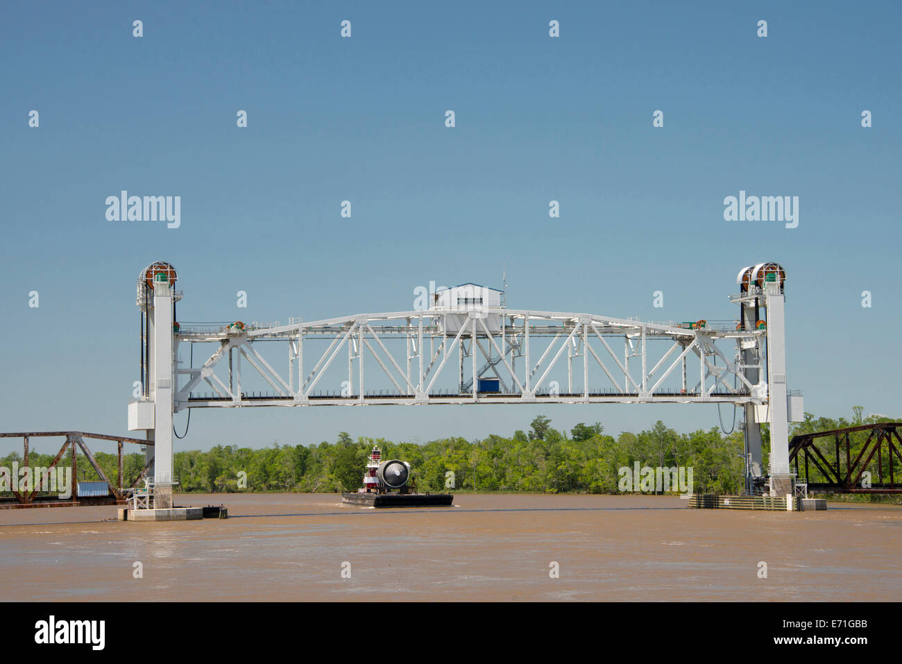 USA, Alabama, Mobile. Mobile River barge traffic with railroad bridge ...