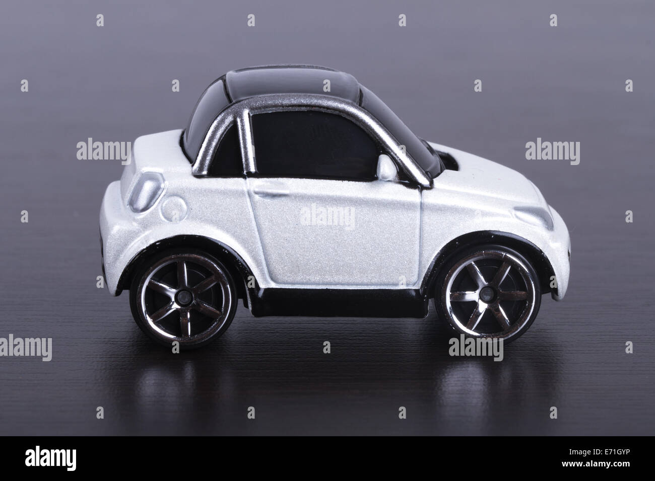 Side view of white, toy, small car on wooden table Stock Photo - Alamy