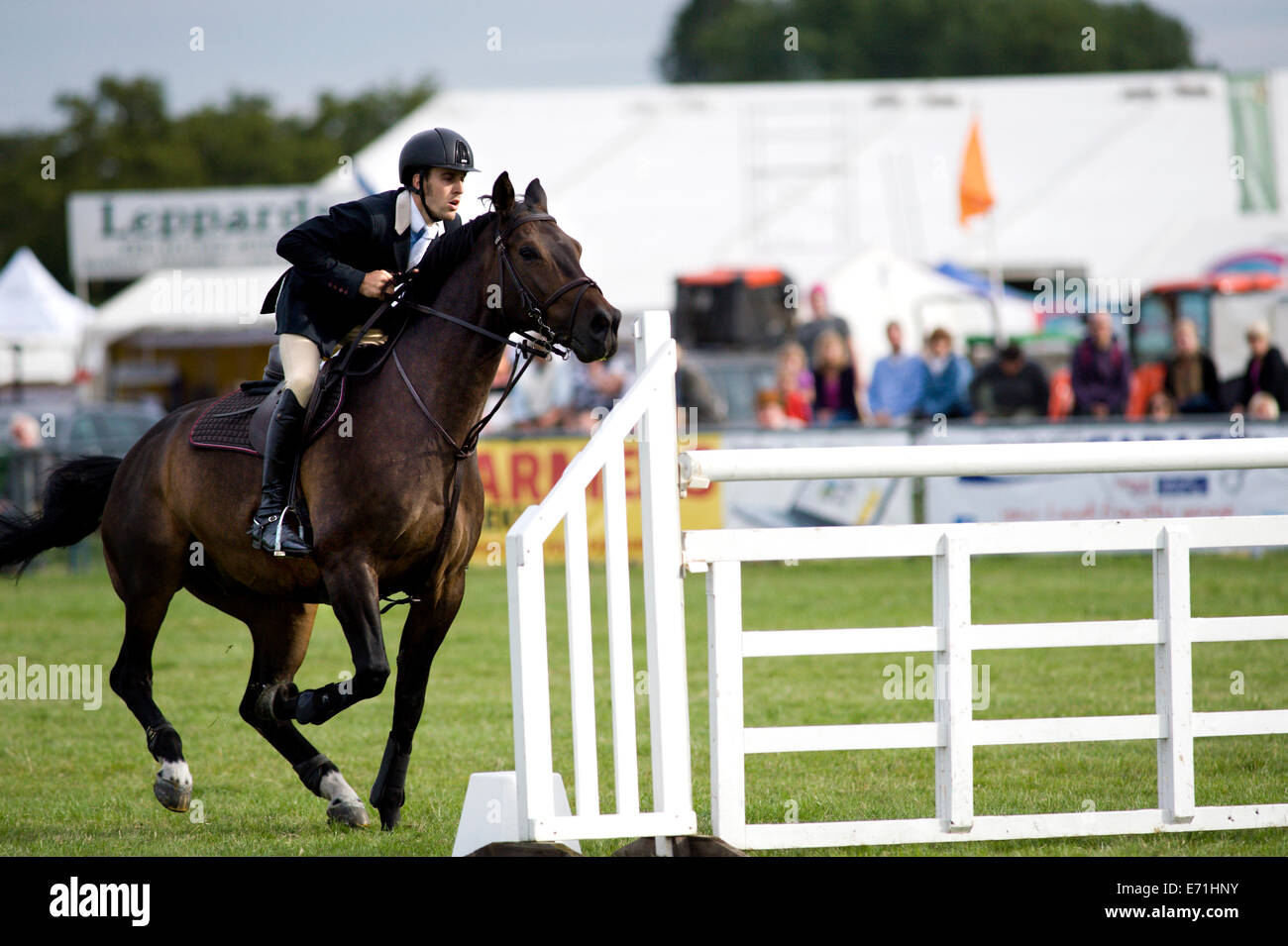 A horse and rider approach a fence in the show jumping competition at ...