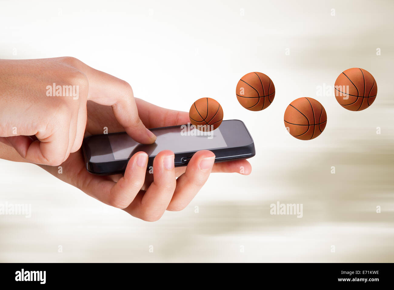 Basketball subject, hand holding mobile phone on blurry fast background ...