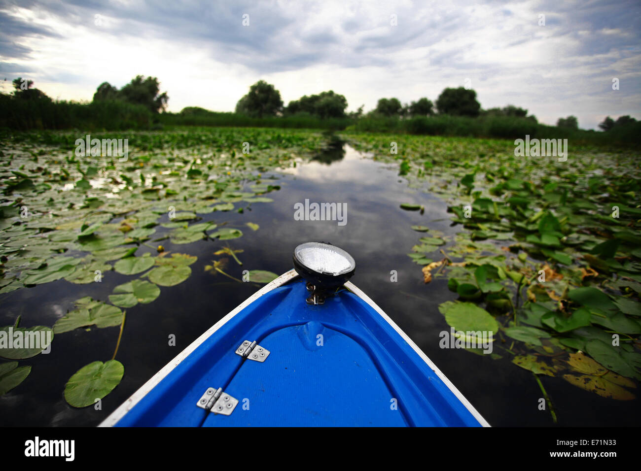 Color picture of a boat on a river bank Stock Photo - Alamy