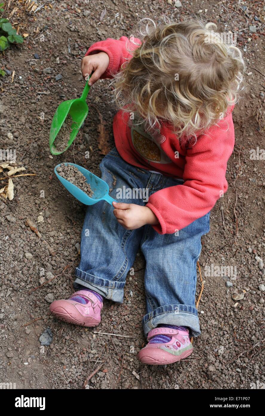 A young child playing in dirt Stock Photo - Alamy