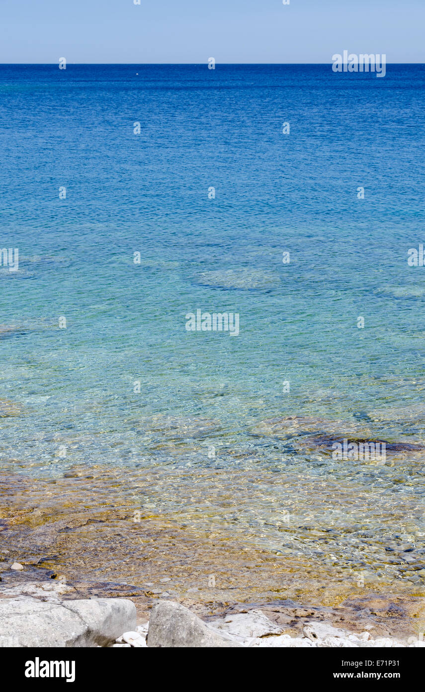 Green and blue water of Huron Lake, Canada under blue sky Stock Photo ...
