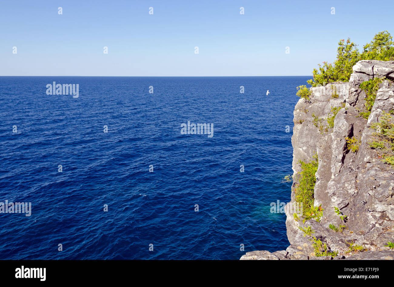 Green and blue water of Huron Lake, Ontario under blue sky Stock Photo ...