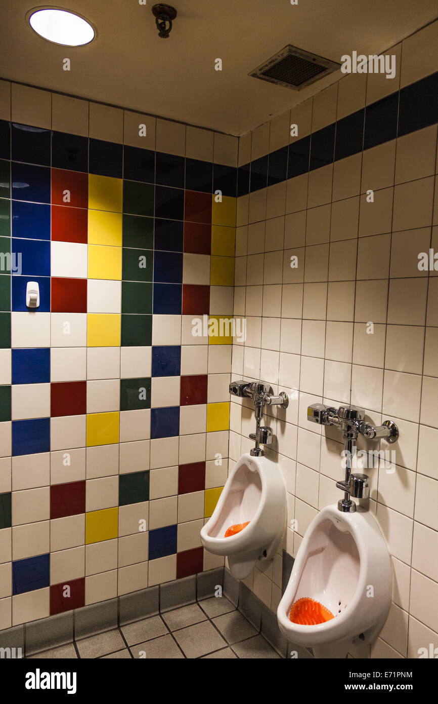 Male washroom with two urinals and colorful tiled wall Stock Photo - Alamy