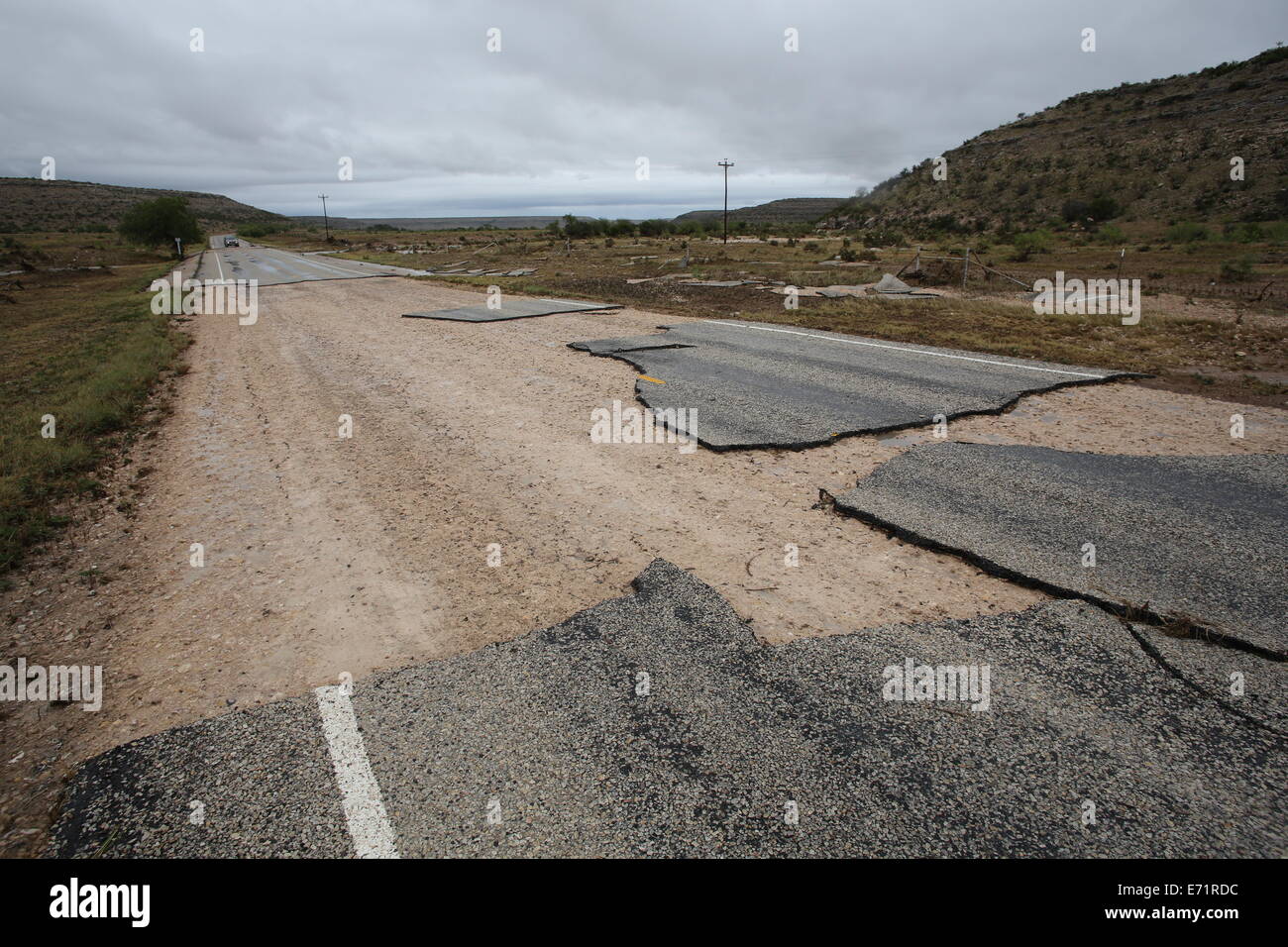 A portion of a road ripped away by a flash flood near San Angelo, Texas ...