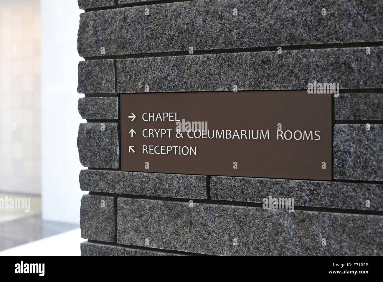 A sign in a mausoleum pointing to chapel, crypt, columbarium and ...