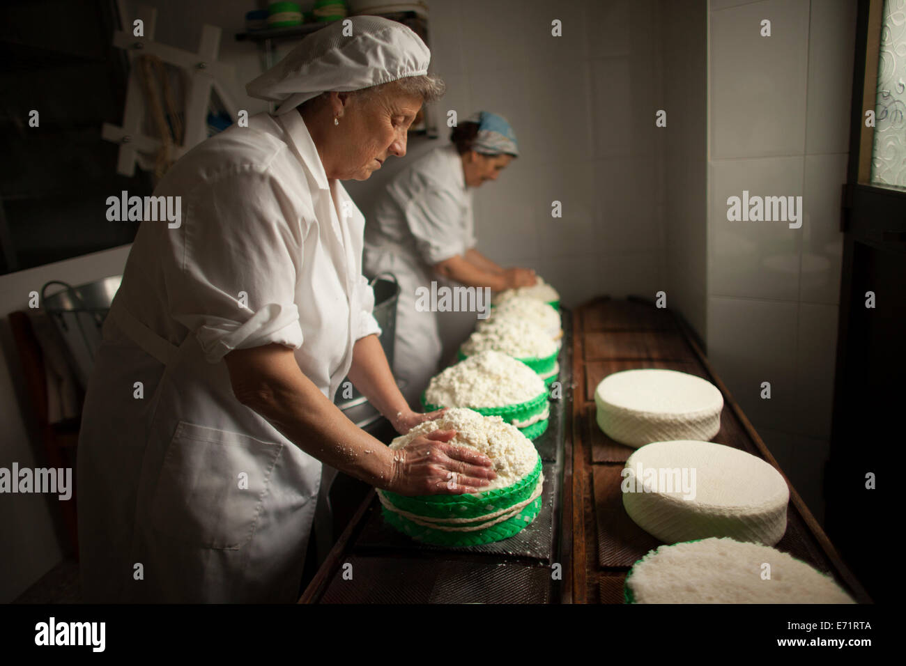 Women work making Pecorino cheese in Quesos Oliva handmade cheese ...