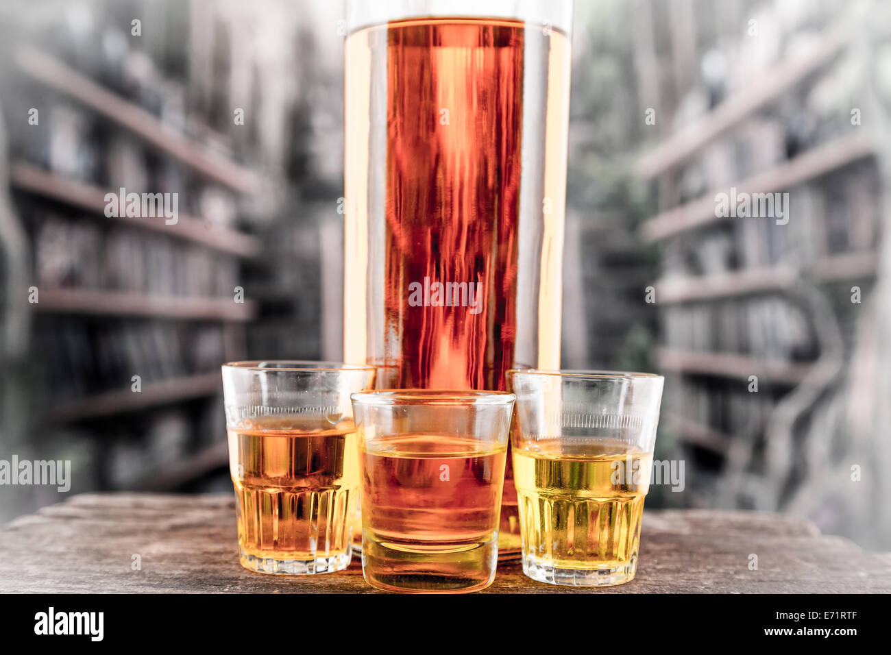 Bottle and glass shots with yellow liqour resembling whiskey, rum ...