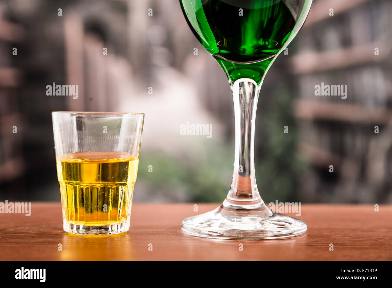 Glass with green cocktail and yellow shot Stock Photo - Alamy
