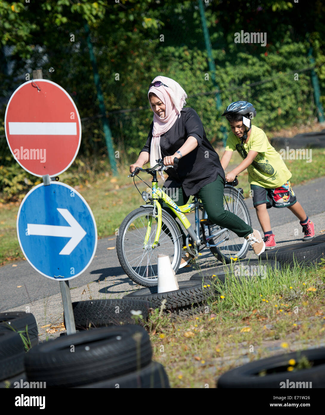 Dresden, Germany. 28th Aug, 2014. A woman from Libya and her son take ...