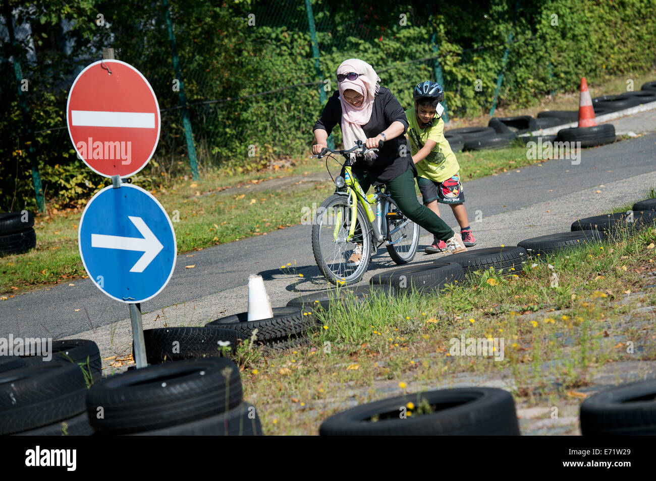 Dresden, Germany. 28th Aug, 2014. A woman from Libya and her son take ...