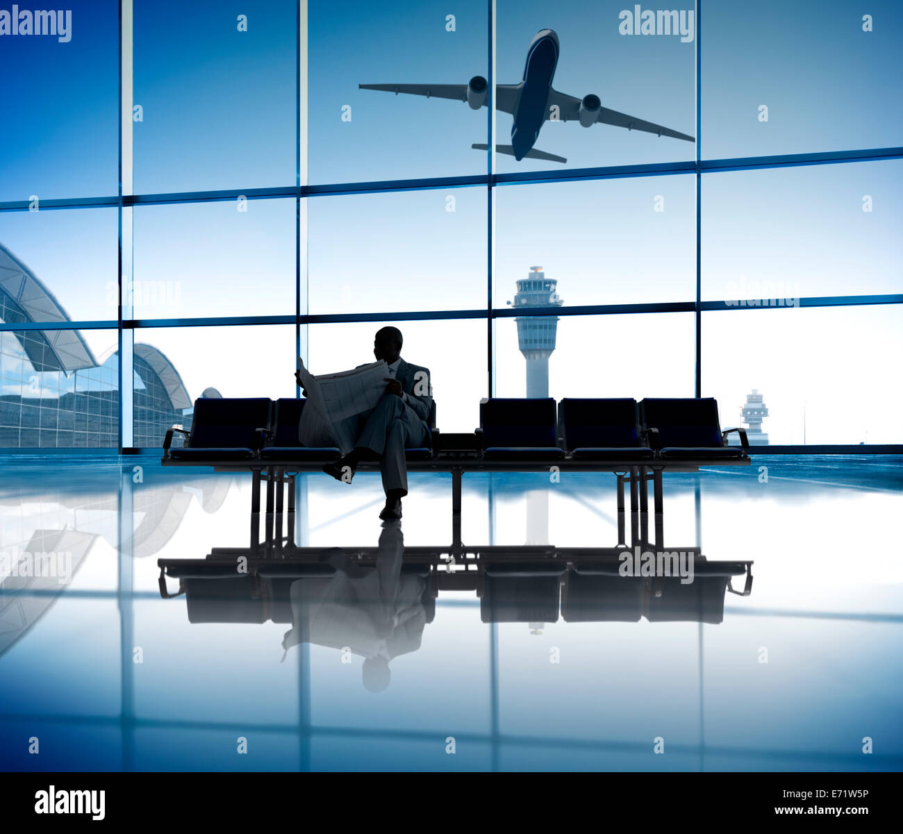 A Businessman Reading the Newspaper While Waiting for His Flight Stock ...