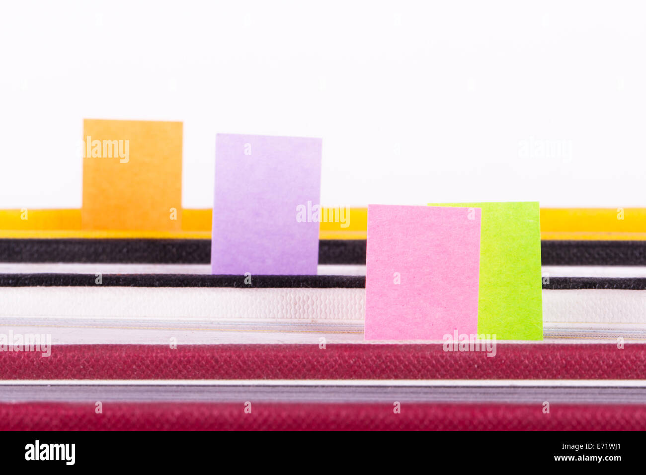 Colorful post it markers inside books, front view, isolated on white ...