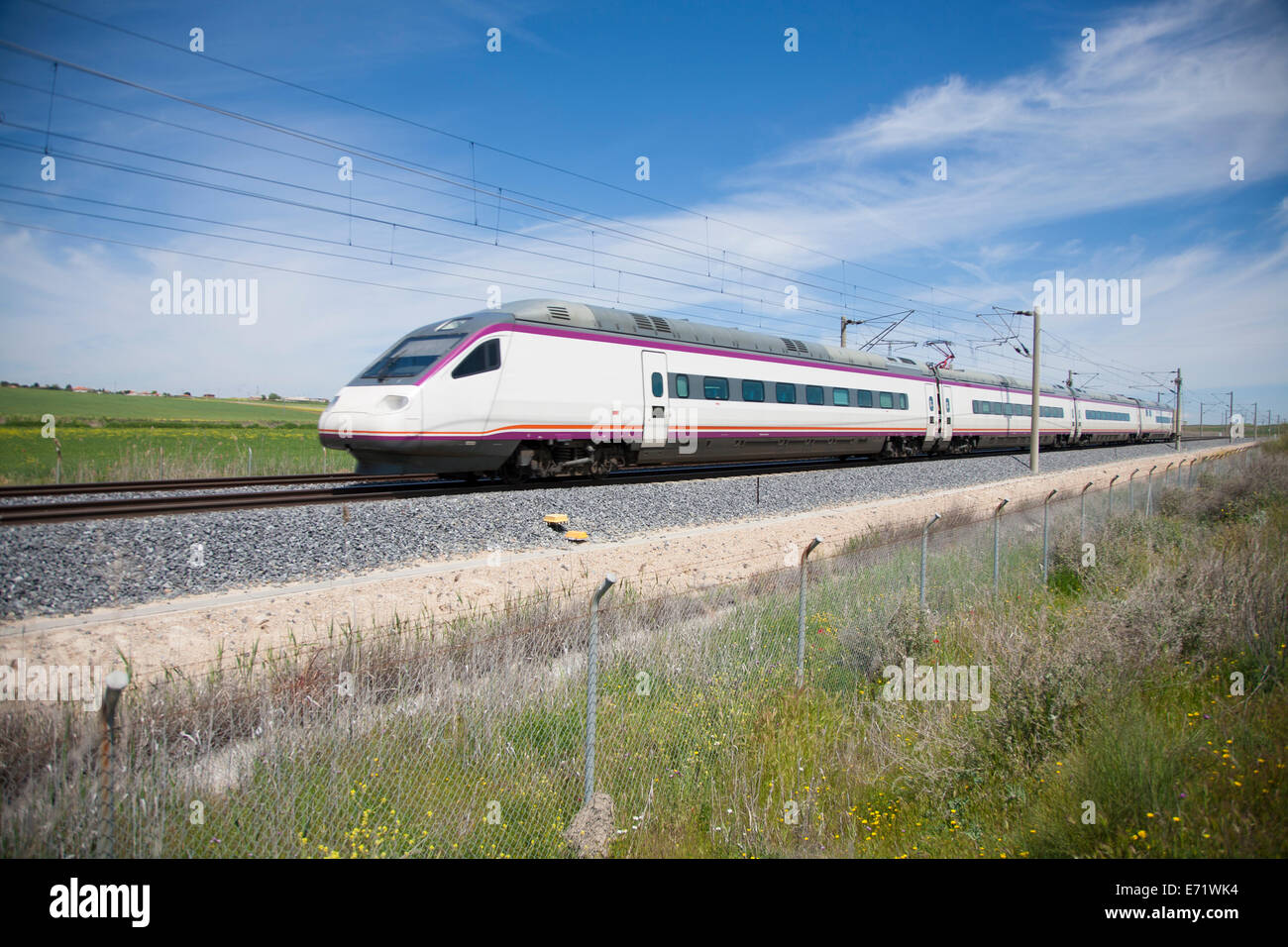 railway with high speed train at a landscape in Spain Stock Photo - Alamy