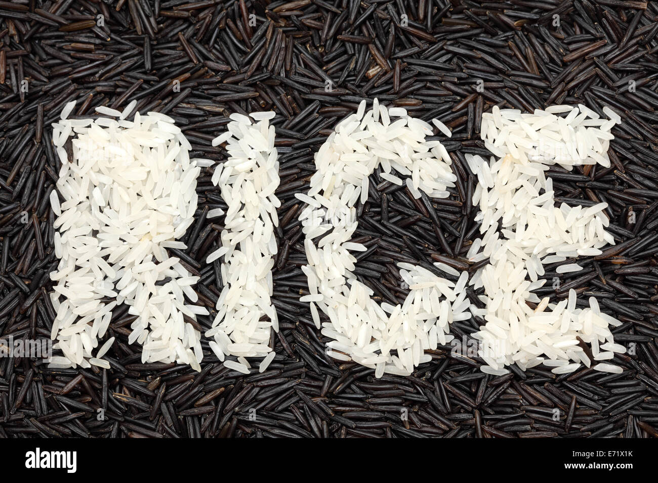 Word "RICE" written with white rice on a wild rice background. Closeup ...