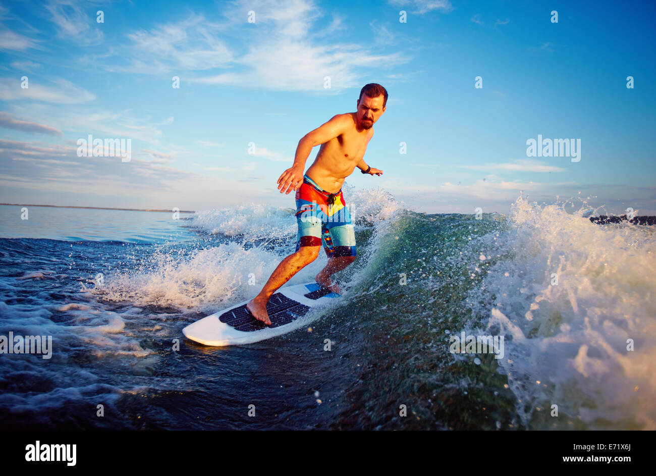 Young man surfboarding on summer vacation Stock Photo - Alamy