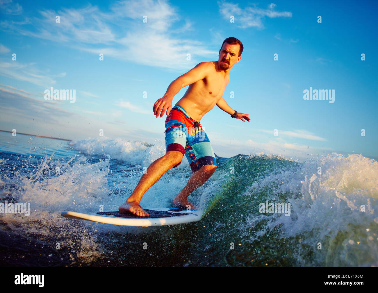 Young man surfboarding in summer Stock Photo - Alamy