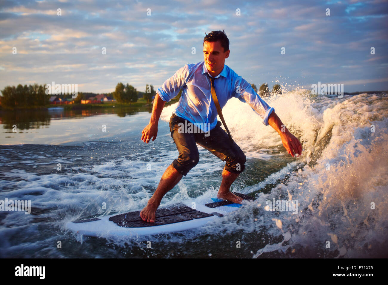 Active young man surfboarding at summer resort Stock Photo - Alamy