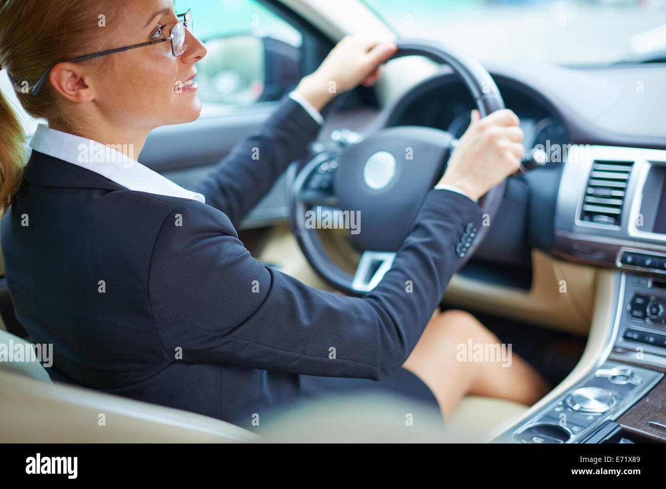 Young businesswoman driving to work Stock Photo - Alamy