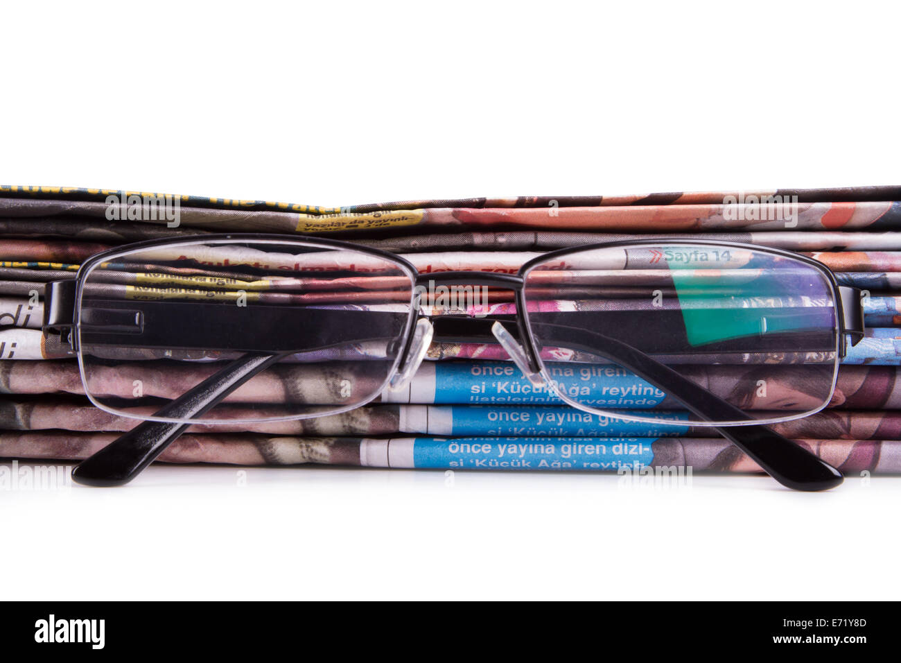 Stack of newspapers and eye glasses, isolated on white background Stock ...
