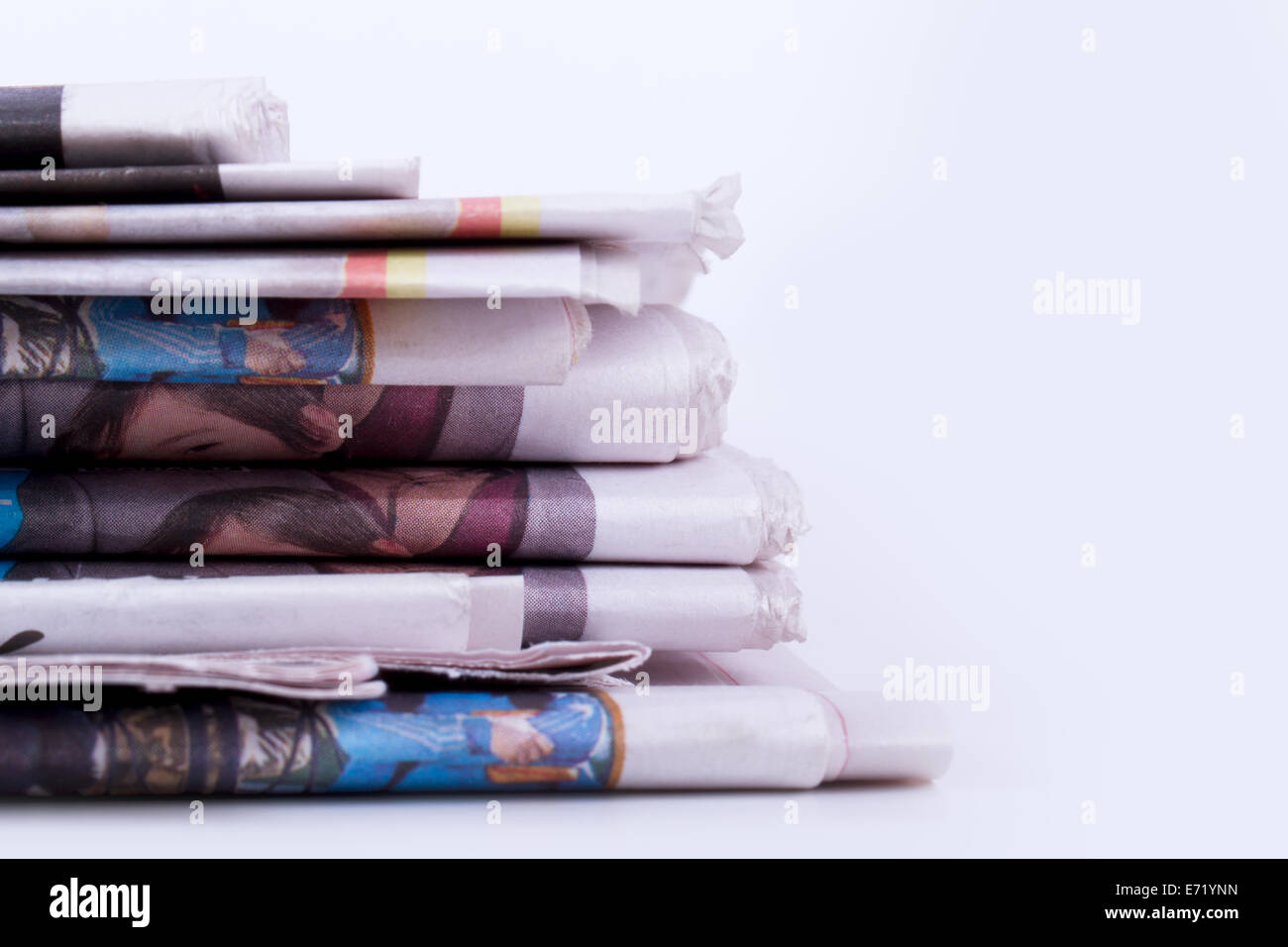 Stack of newspapers, isolated on white background Stock Photo - Alamy