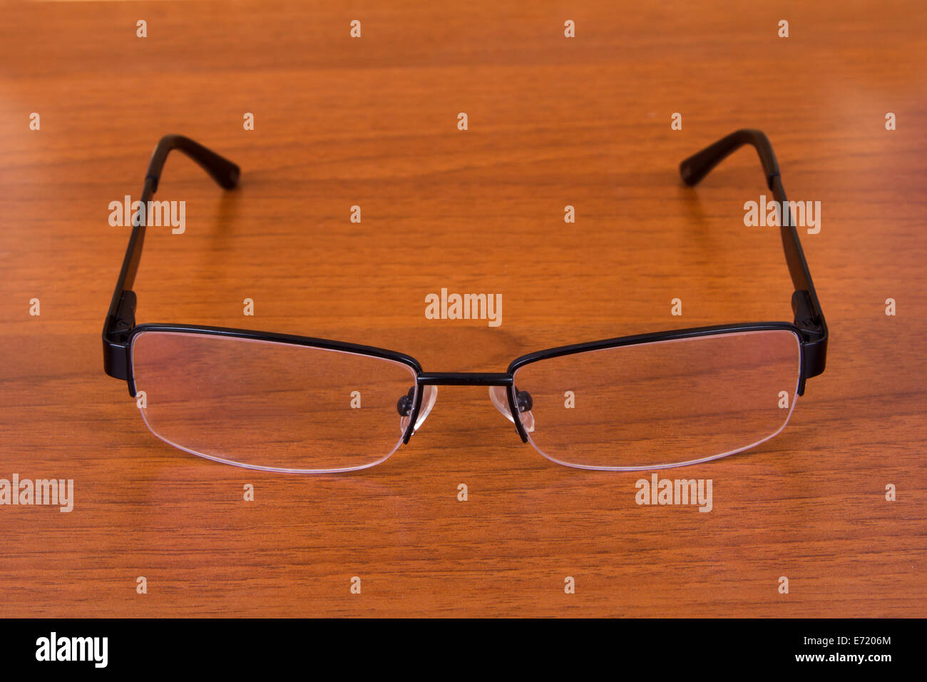 Eyeglasses on wooden table Stock Photo - Alamy
