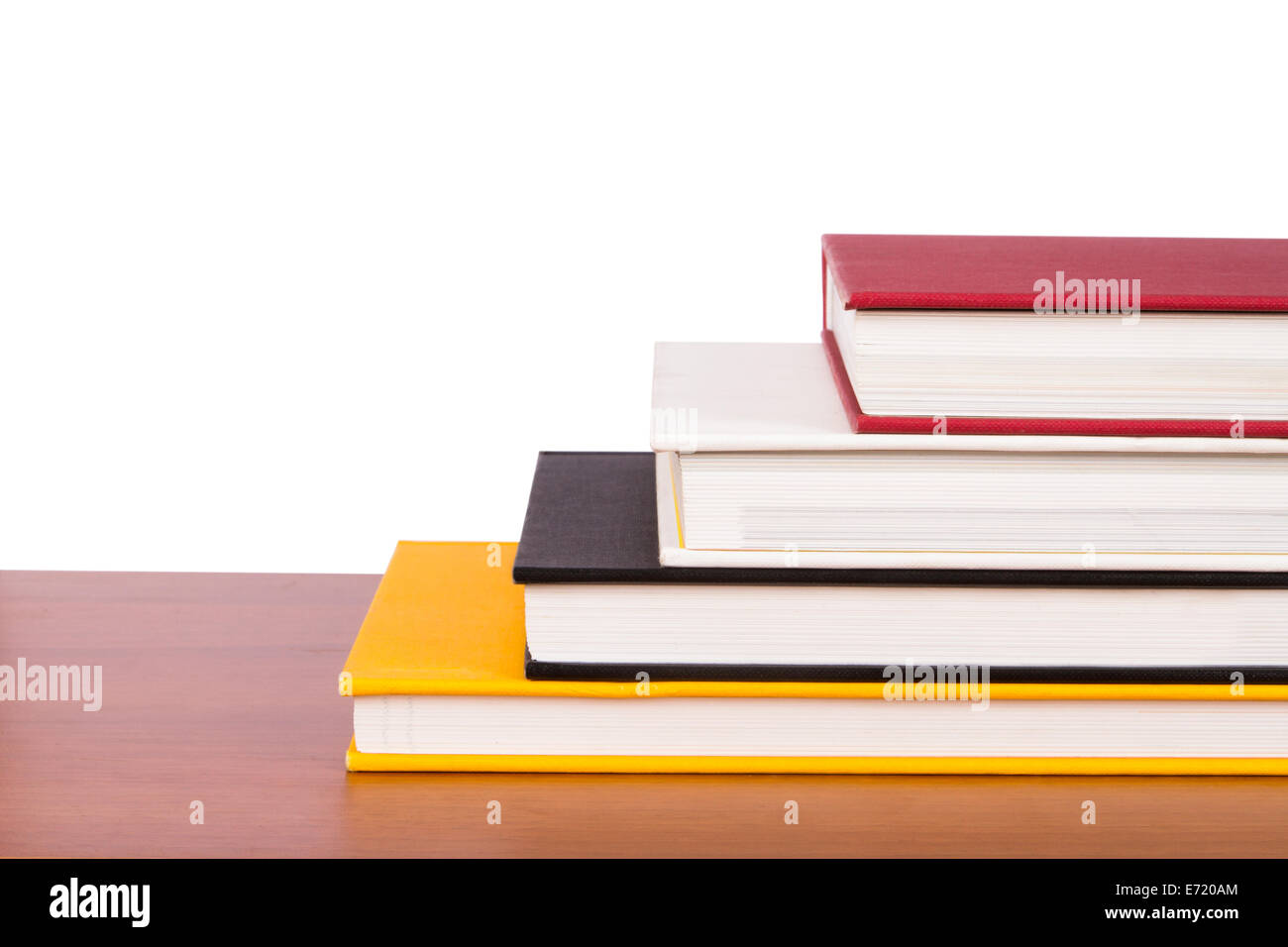 Books with covers on wooden table, side view, isolated on white ...