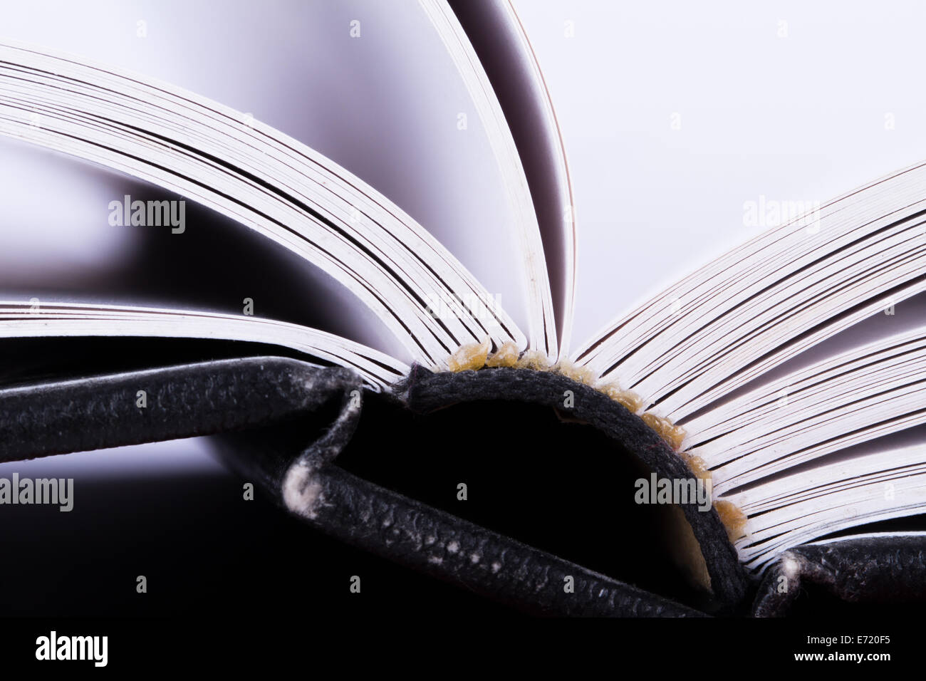 Detail view of open book on white Stock Photo - Alamy
