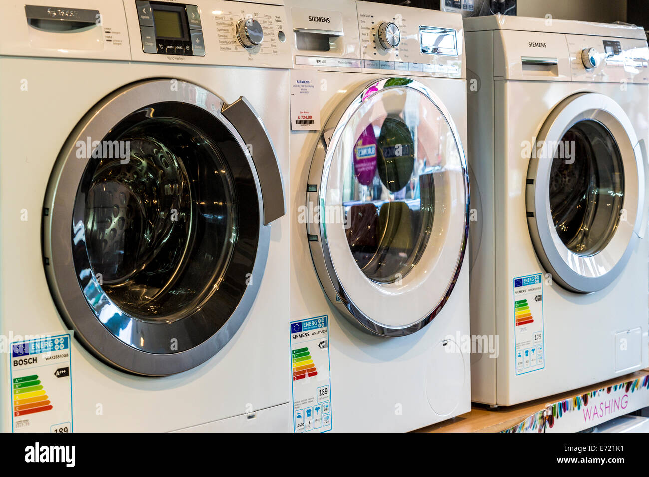 Front loading washing machines in an electrical store, Norfolk, UK ...