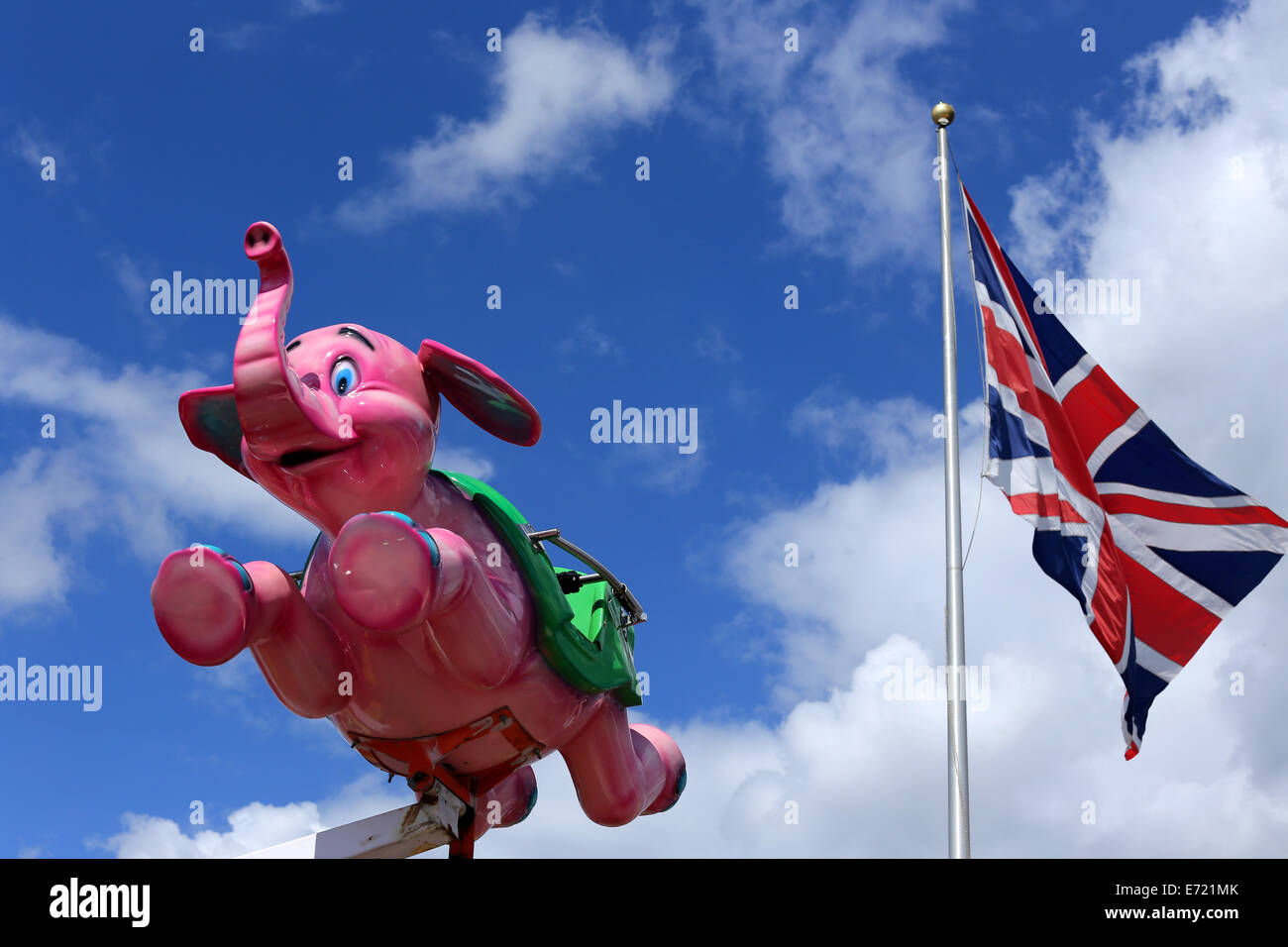 Pink elephant is seen flying in the air at a fairground with a Union ...