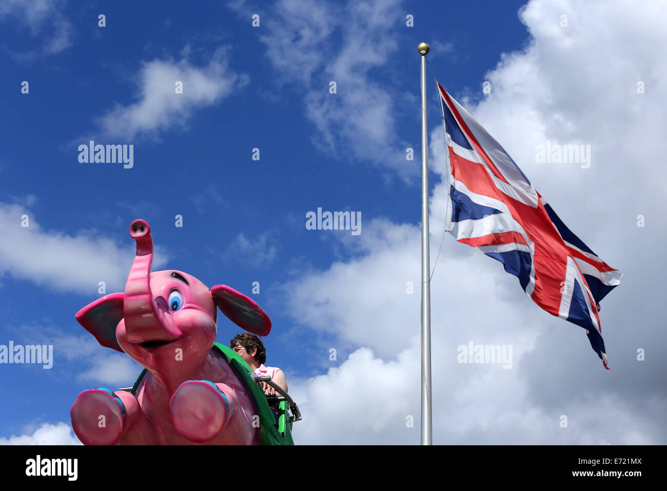 Pink elephant is seen flying in the air at a fairground with a Union ...