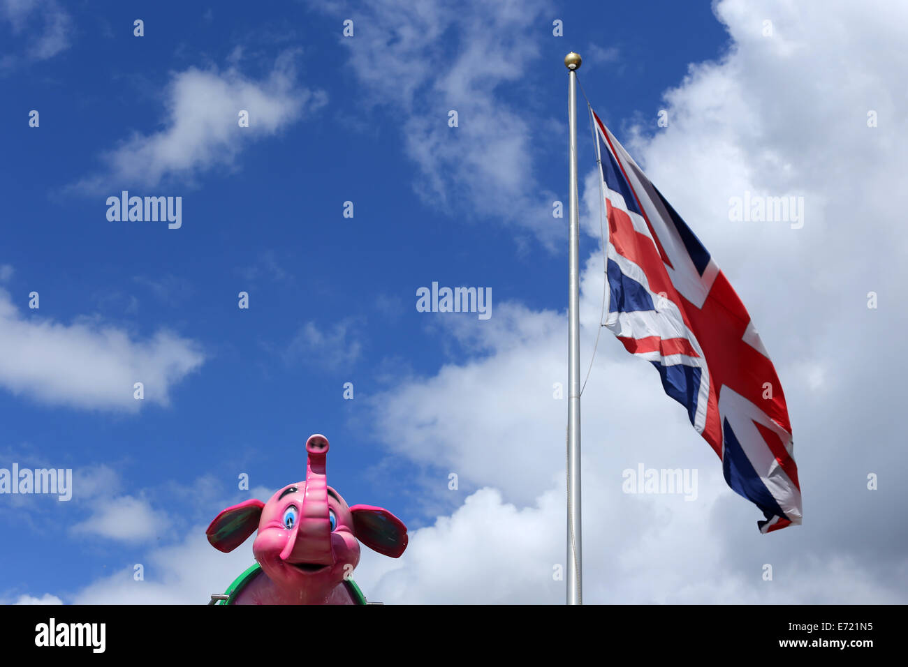 Pink elephant is seen flying in the air at a fairground with a Union ...