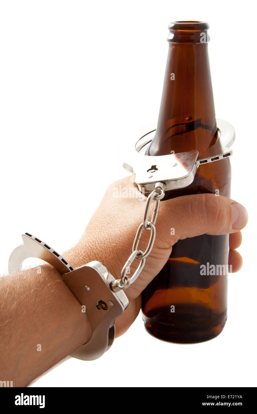 Hand with handcuffs and bottle of beer over whitw Stock Photo - Alamy