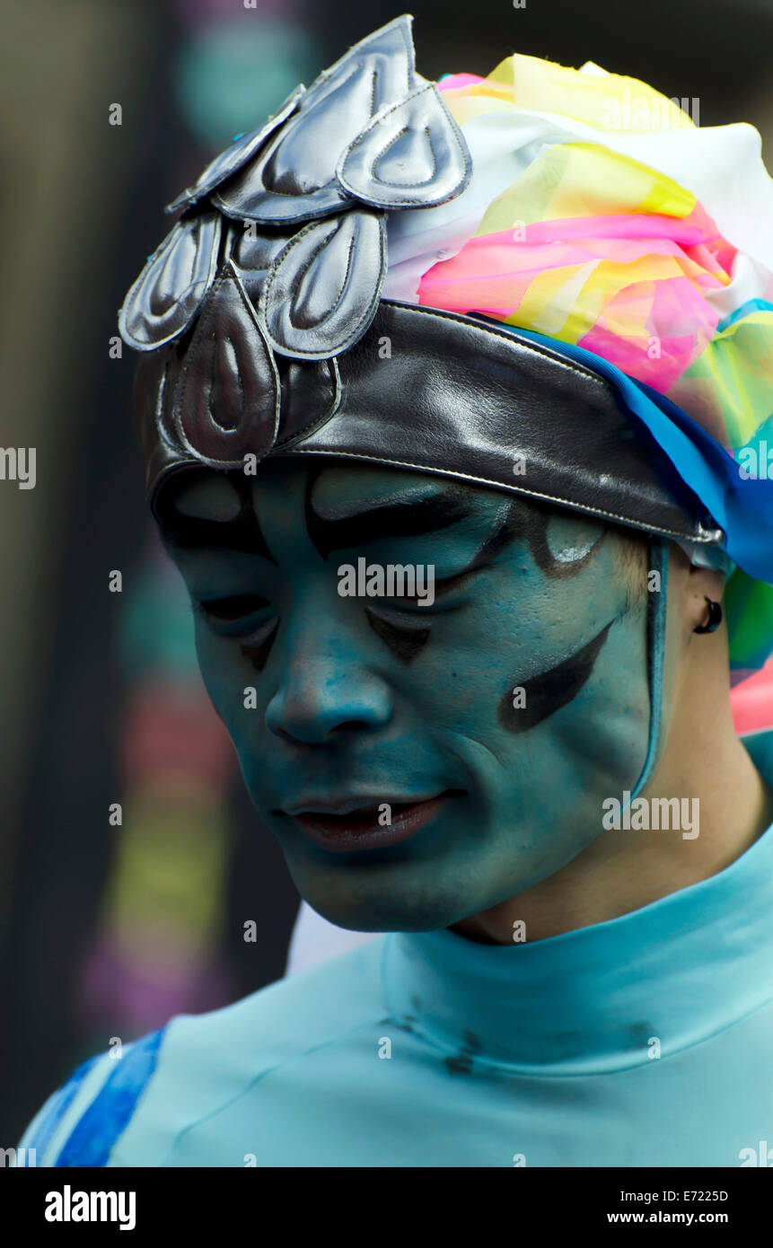 Japanese man with a blue-painted face and strange hat promoting a show ...